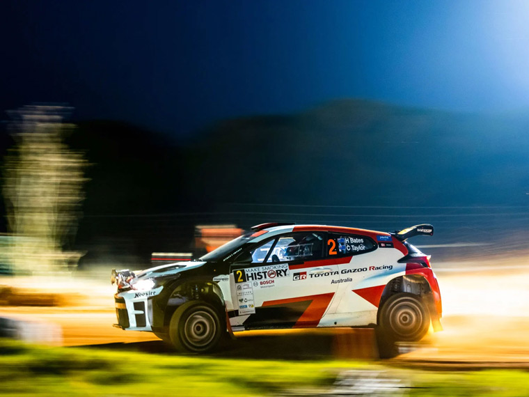 Dynamic side view of a Toyota GR Yaris AP4 driving on a blurred rally ...