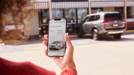 woman holding phone looking at screen